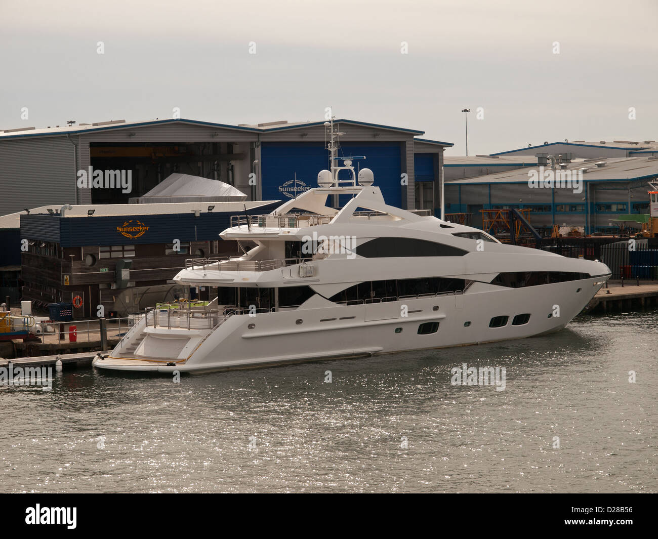 Sunseeker boat berthed adjacent to the Sunseeker factory Poole Dorset ...