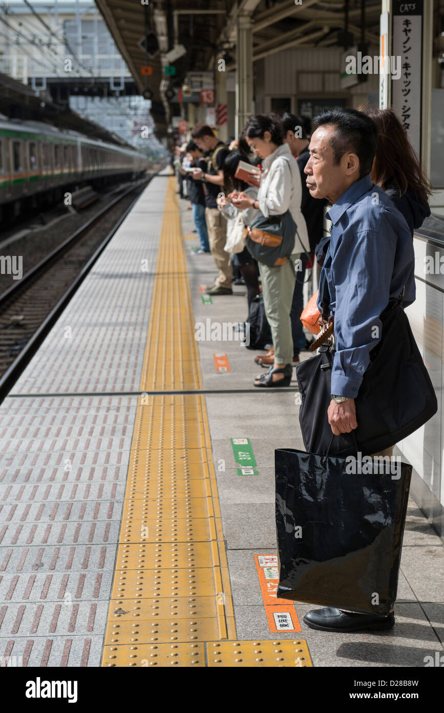 Japanese Commuters Patiently Waiting for the morning Train to Tokyo in ...