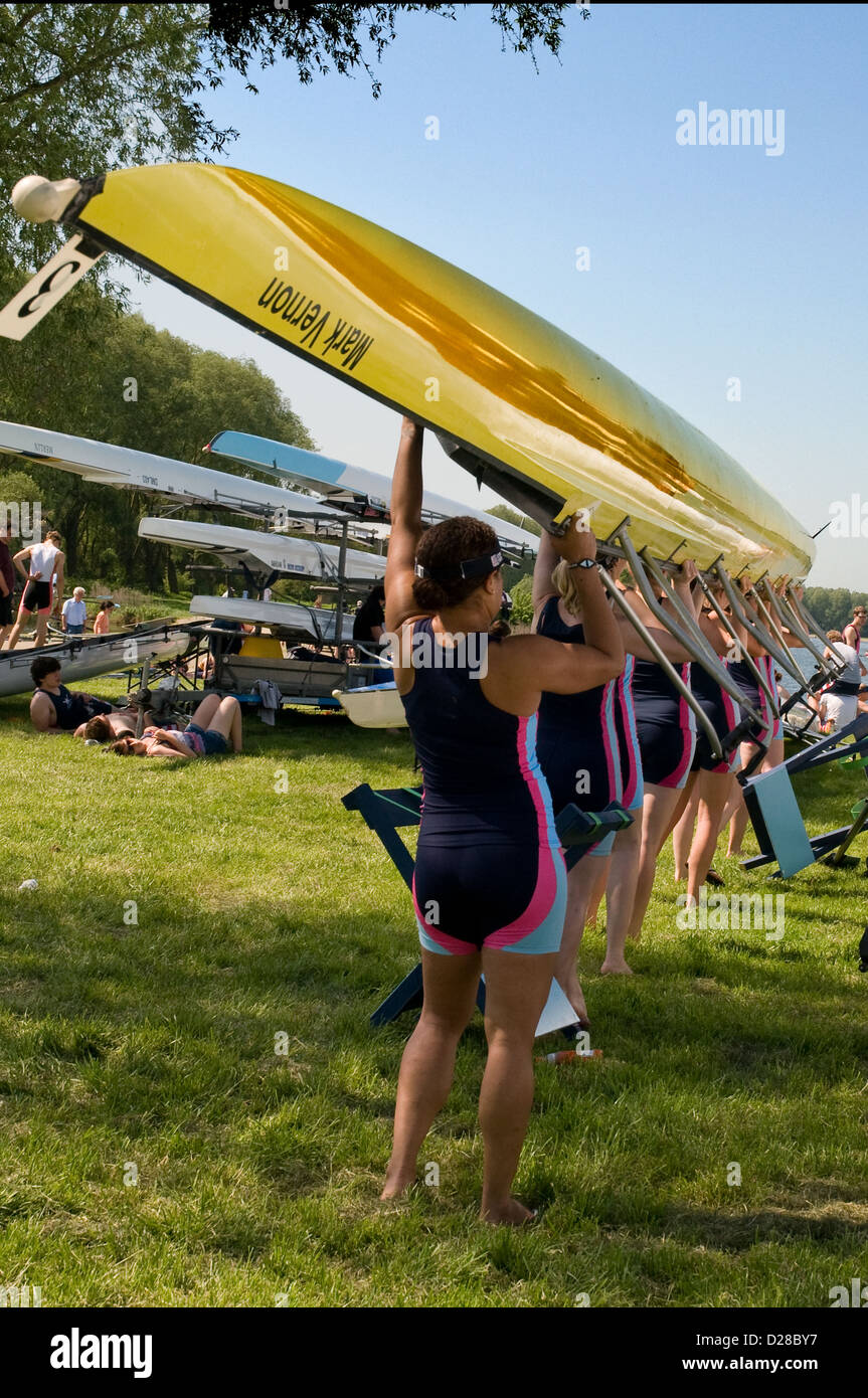 A womens rowing crew lifts an Eight to heads ready to race Stock Photo ...