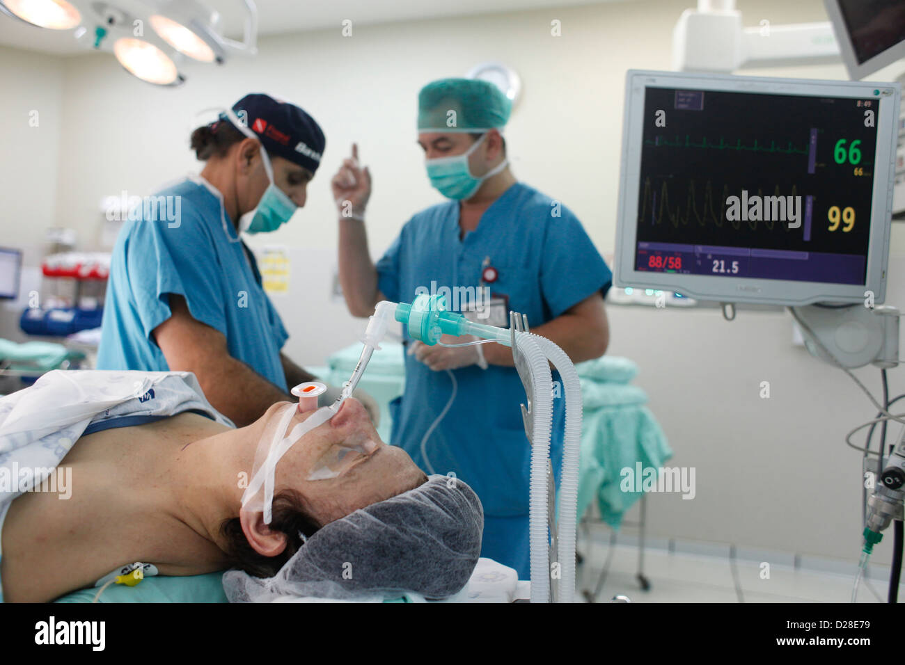 Surgeons wearing surgical mask performing operation in operating room ...