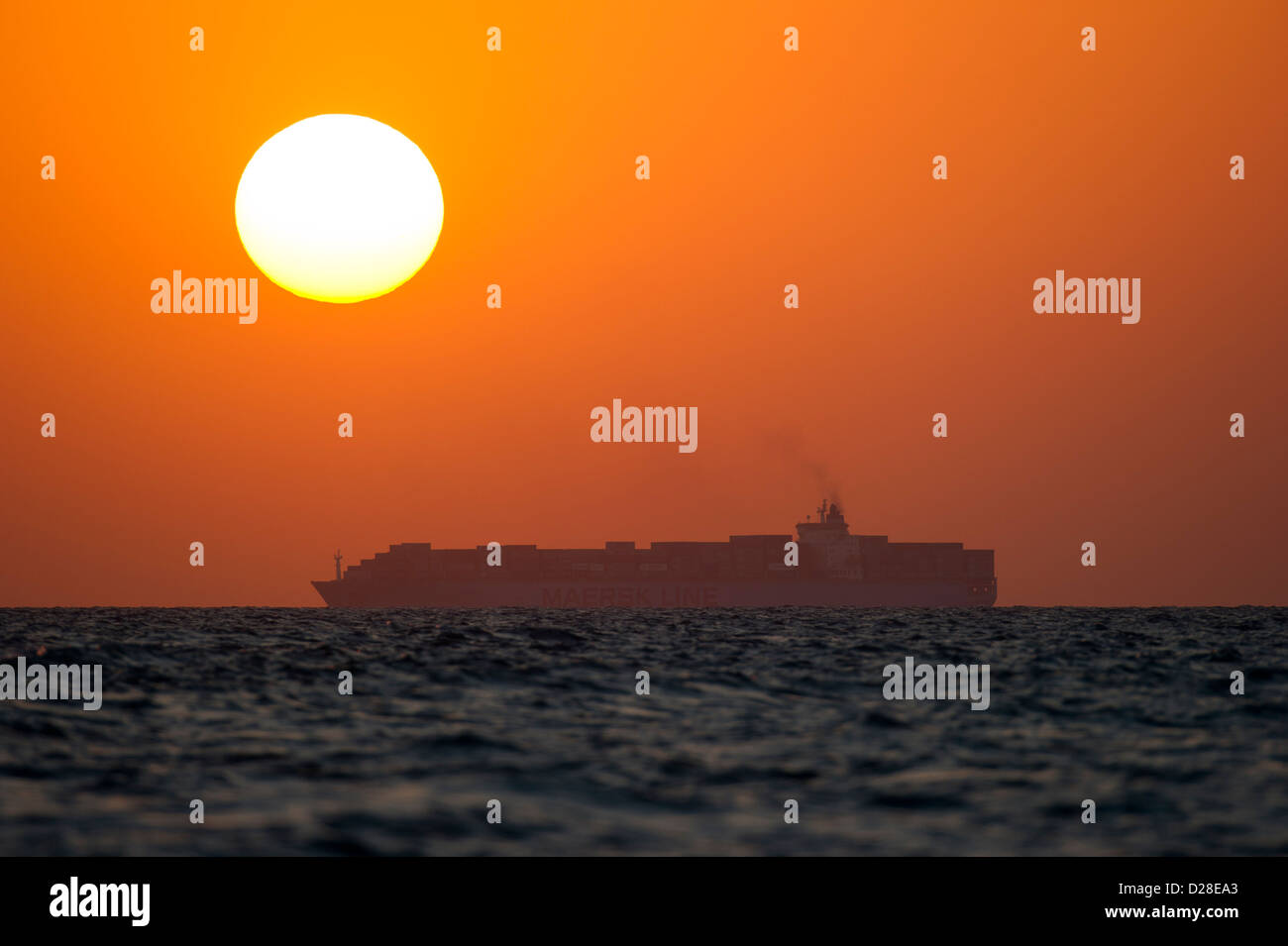 Container ship at sea at sunset Stock Photo - Alamy