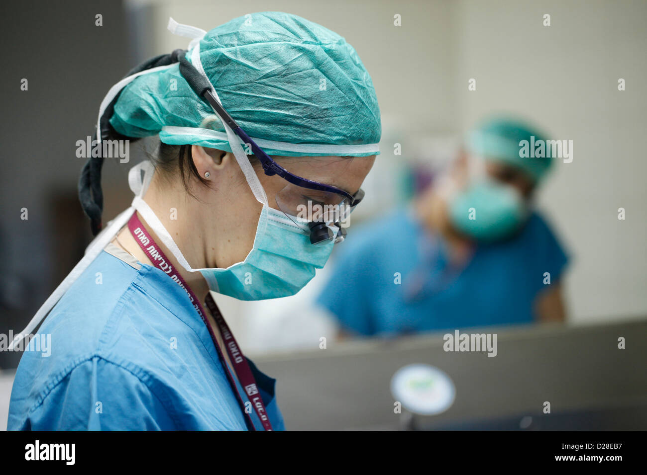 Surgeons wearing surgical mask performing operation in operating room ...