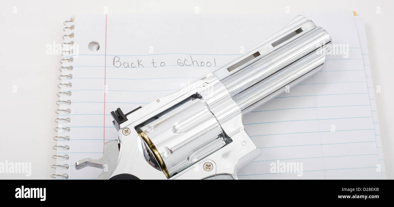 Handgun with school notebook paper Stock Photo - Alamy