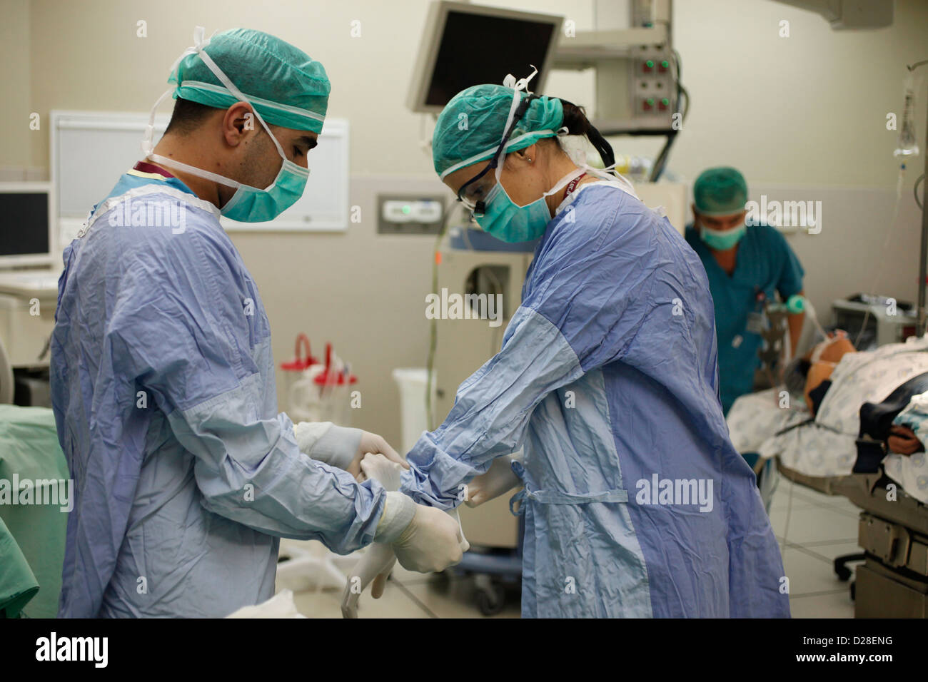 Surgeons wearing surgical mask preparing for operation in operating ...