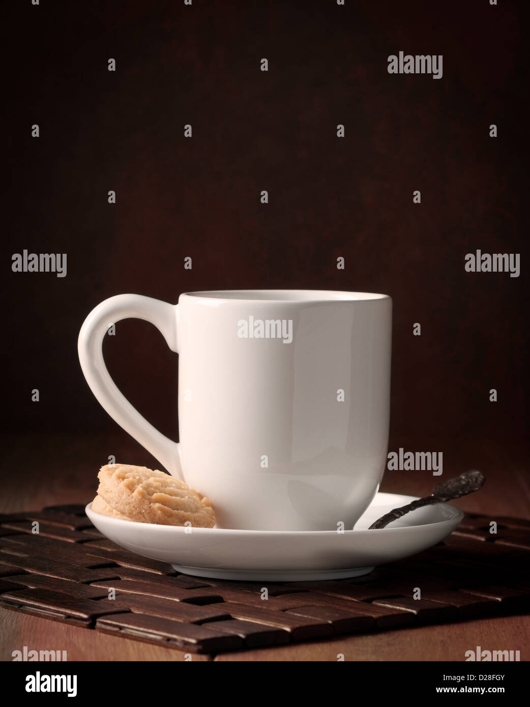 Coffee cup and saucer with biscuits on wooden table Stock Photo - Alamy