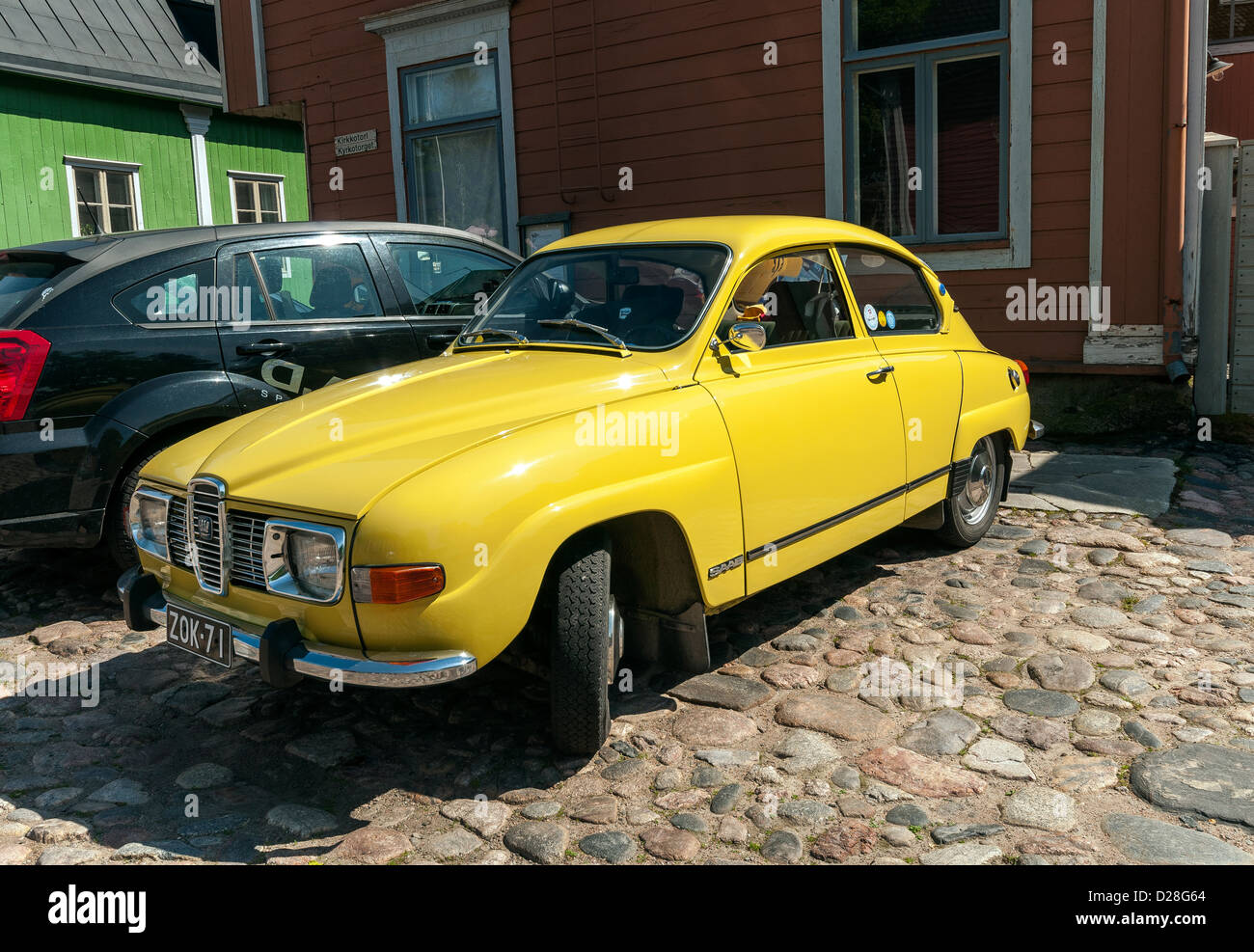 Old authentic yellow Saab parked on cobbled street in Old Porvoo ...