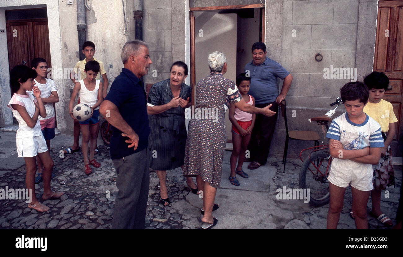 Italians arguing with children looking on, in a mountain village in ...