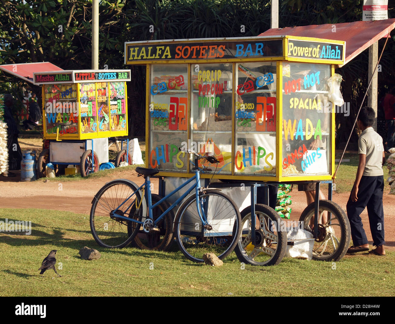 Brightly decorated fast food carts with attendant crow and bicycle on ...