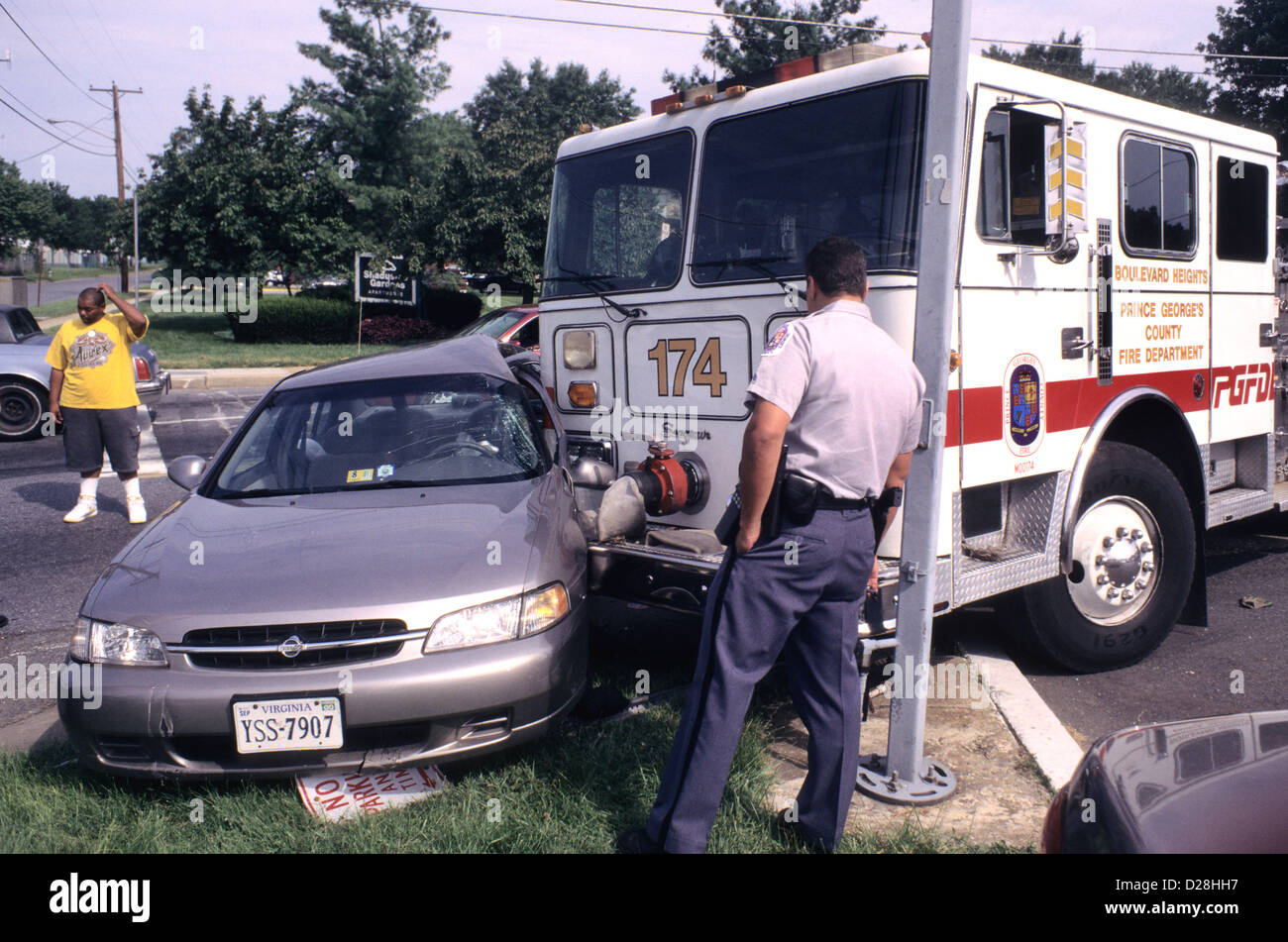 Police officer investigate an auto accident where a fire truck hit a ...