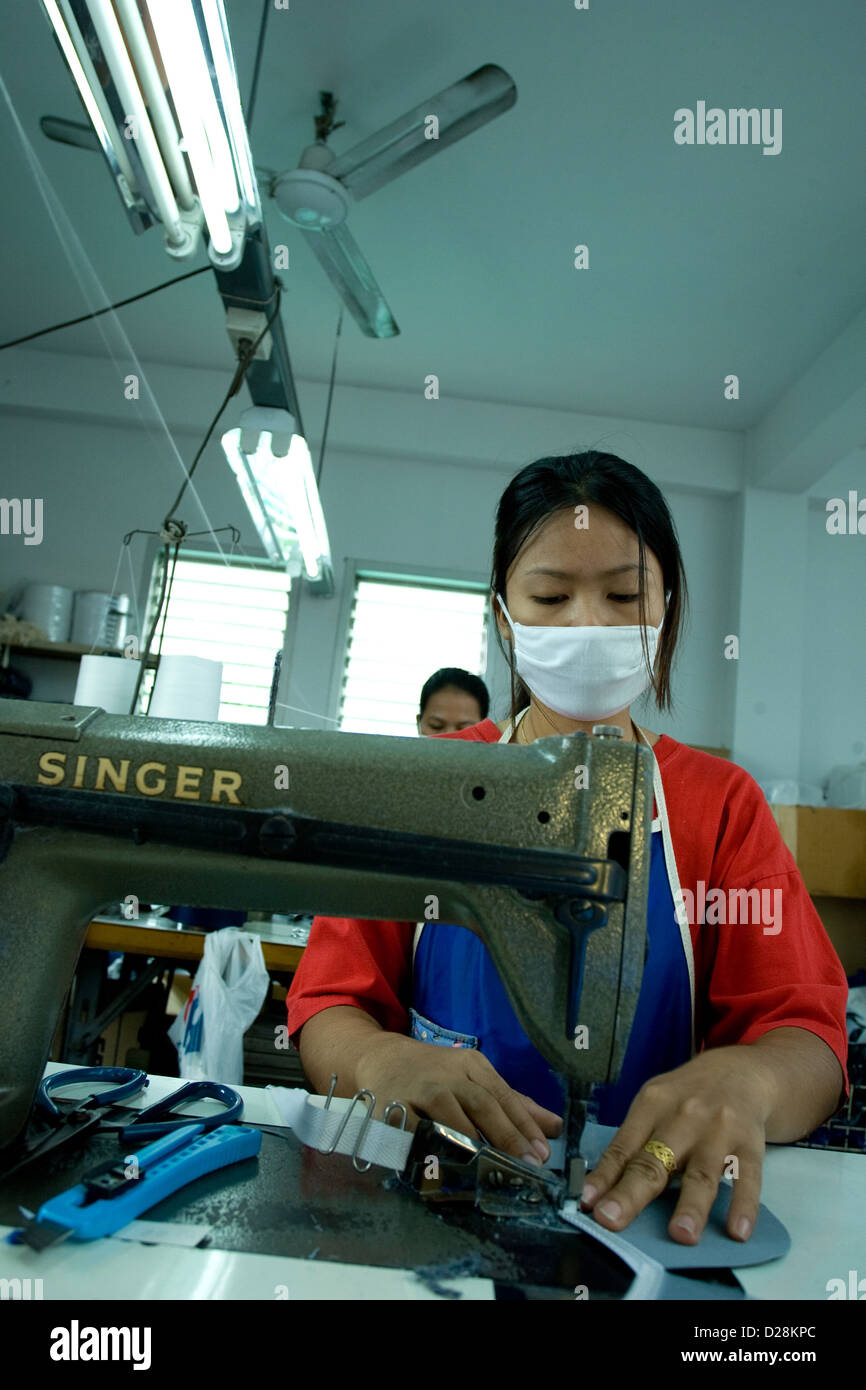 women working on swing machine in a clothing factories, In Bangkok ...