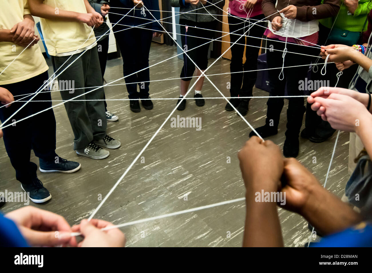 School children play a game that demonstrates their interconnectedness ...