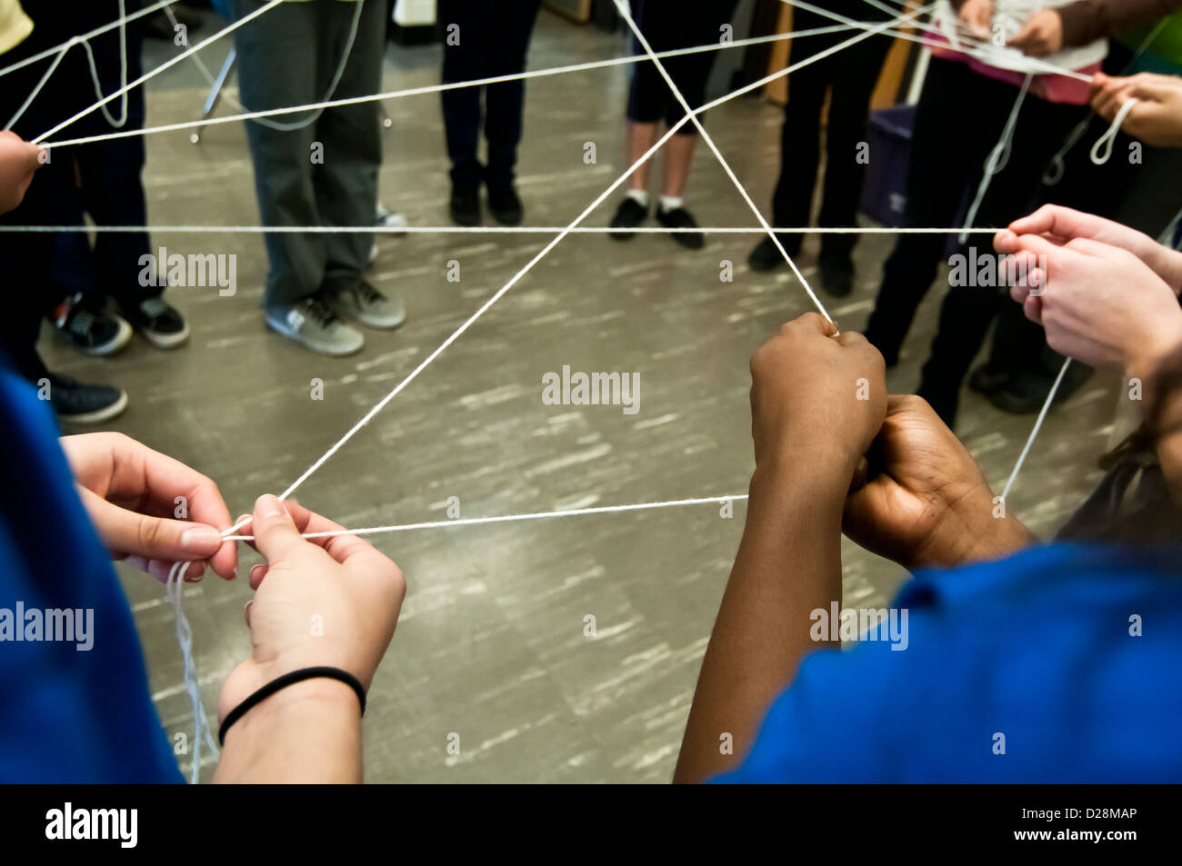 School children play a game that demonstrates their interconnectedness ...