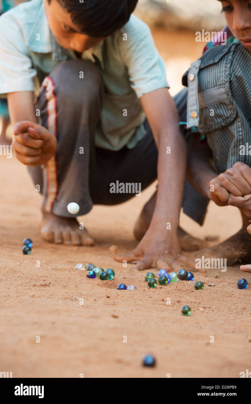 Indian boys playing marbles in a rural Indian village. Andhra Pradesh ...