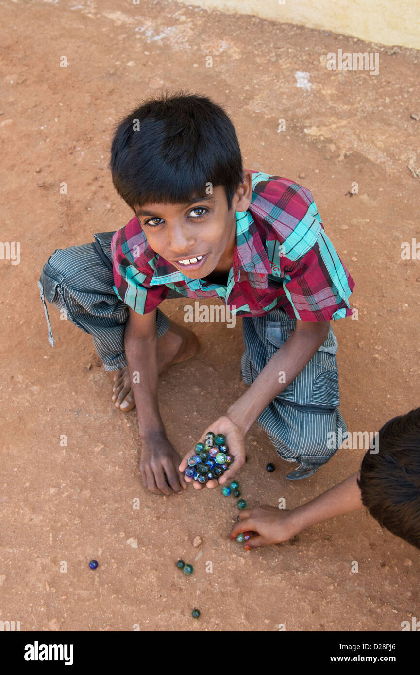 Indian boys playing marbles in a rural Indian village. Andhra Pradesh ...