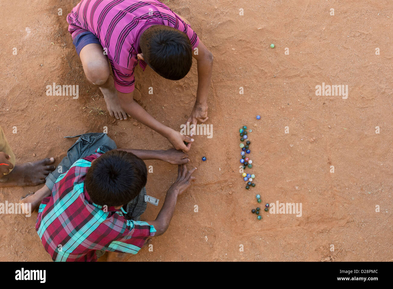 Boys playing game marbles in hi-res stock photography and images - Alamy