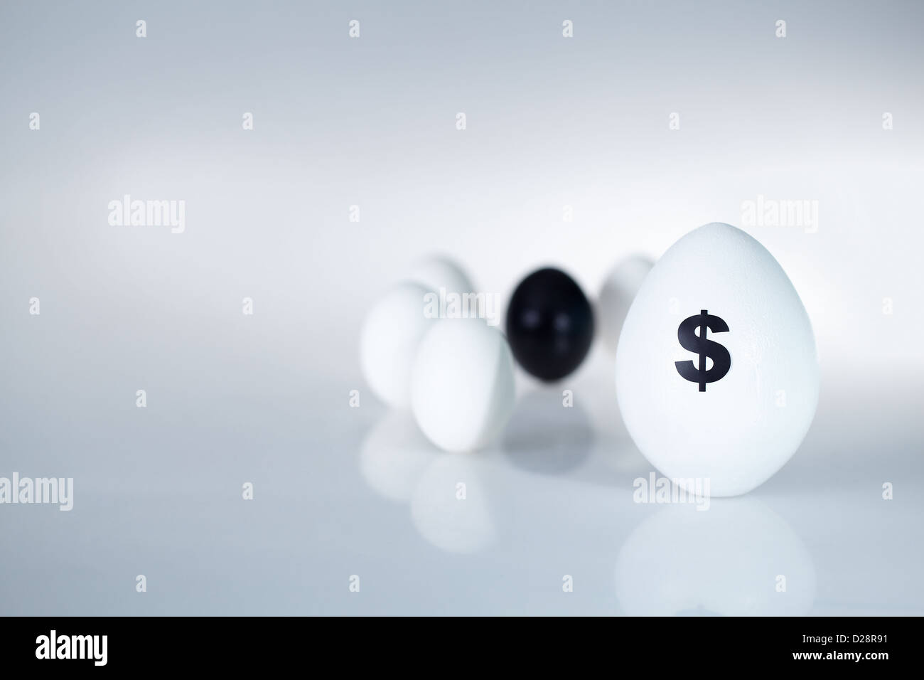 Image of big white egg with dollar sign on background of small eggs ...