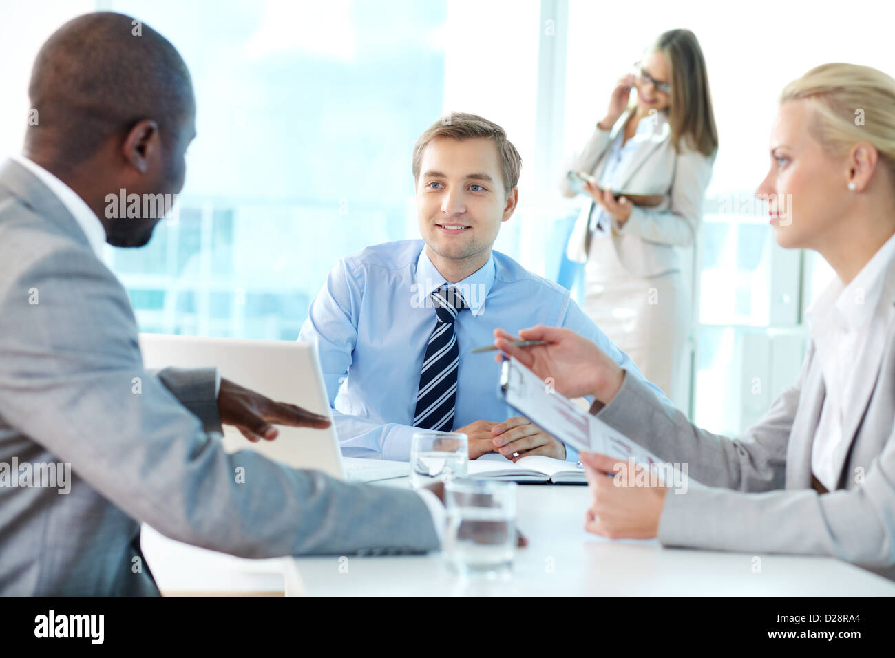 Portrait of confident boss explaining strategy to his partners at ...