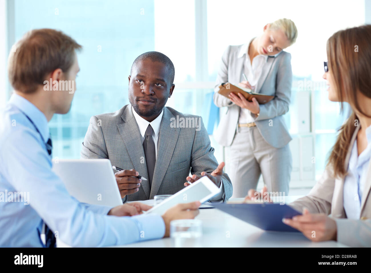 Portrait of boss looking at his employee sitting near by Stock Photo ...