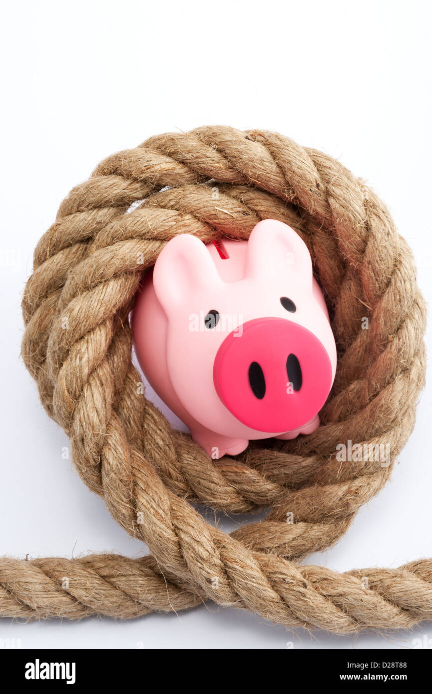 Piggy bank tied by rope on white background Stock Photo - Alamy