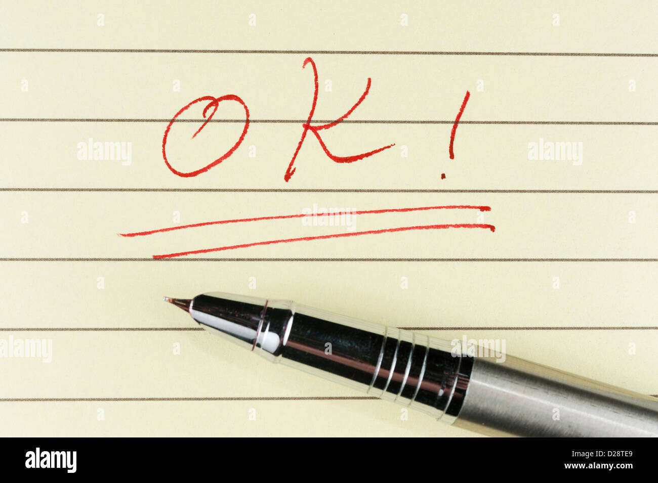 ok word written on lined paper with a pen on it Stock Photo - Alamy