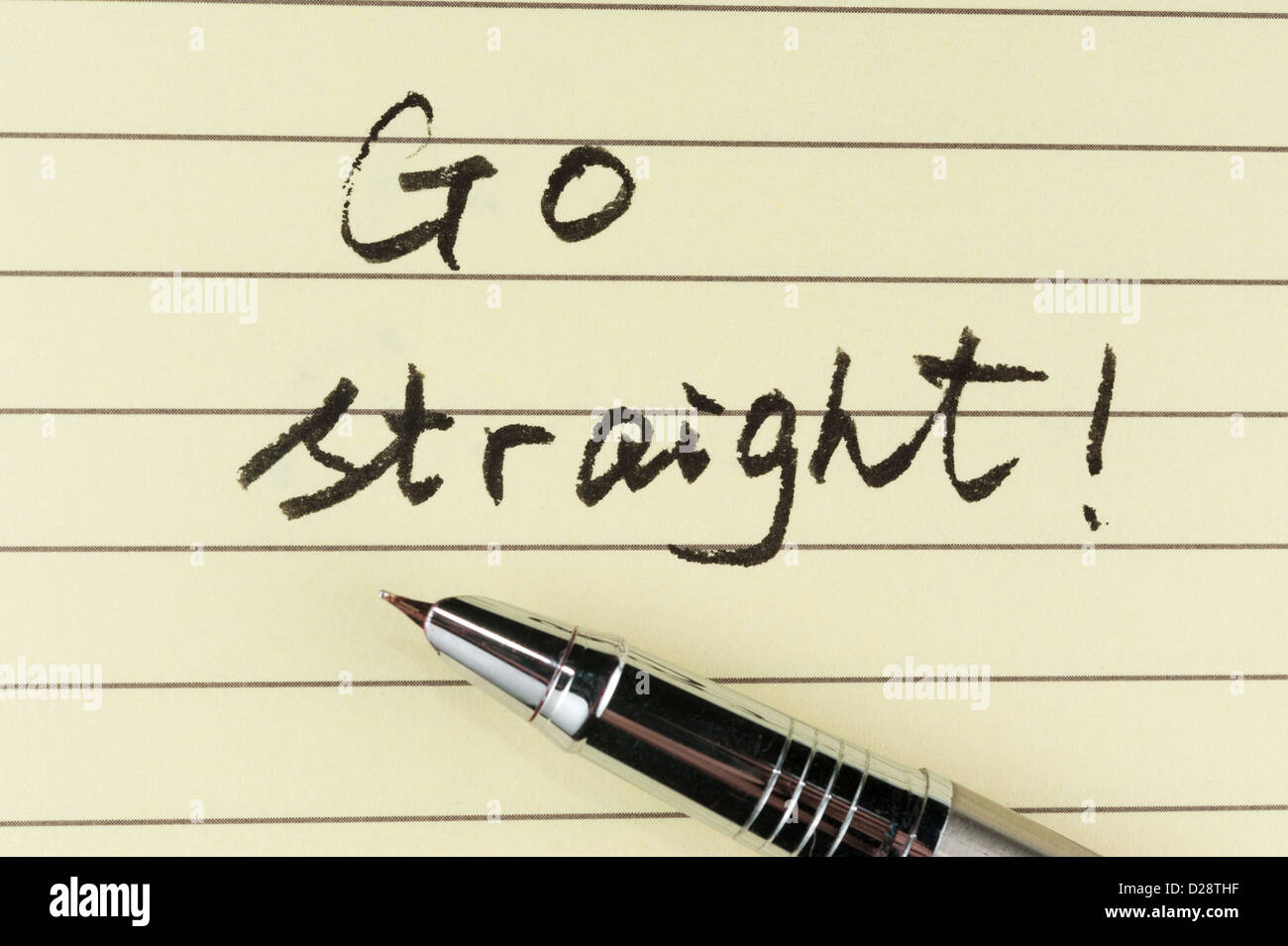 Go straight words written on lined paper with a pen on it Stock Photo ...
