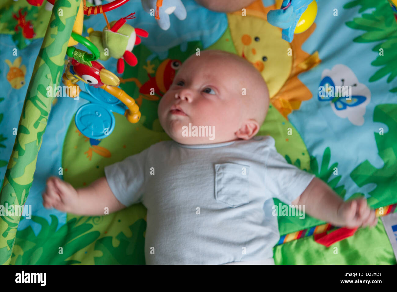 Baby on play mat Stock Photo - Alamy