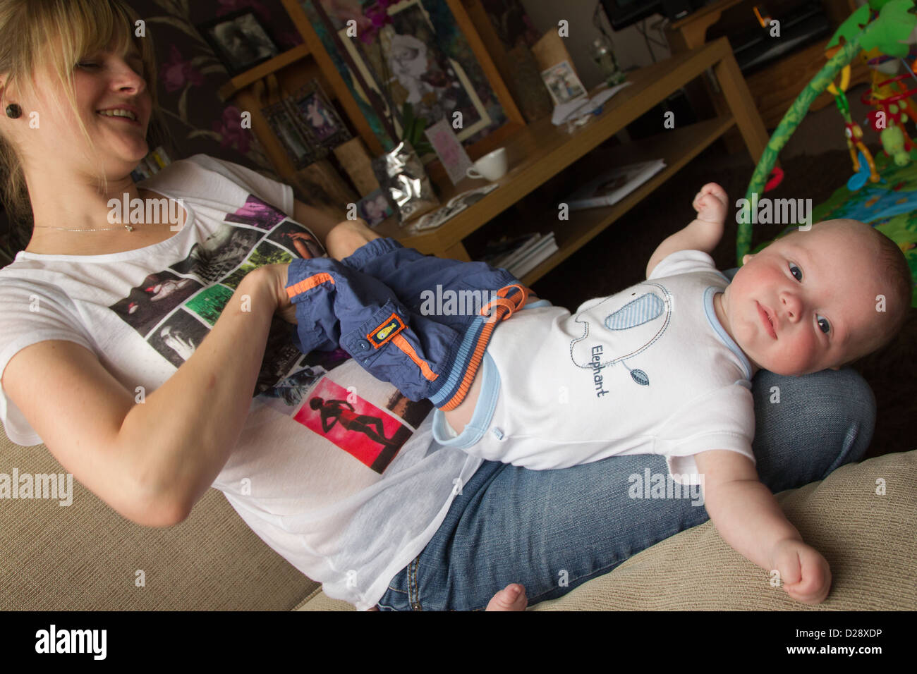 Mother dressing baby Stock Photo - Alamy