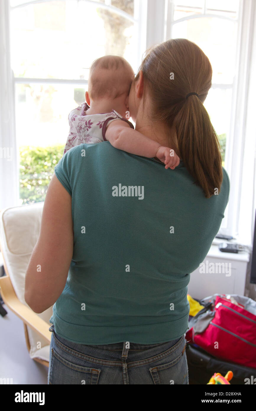 Mother & baby looking out of window Stock Photo - Alamy