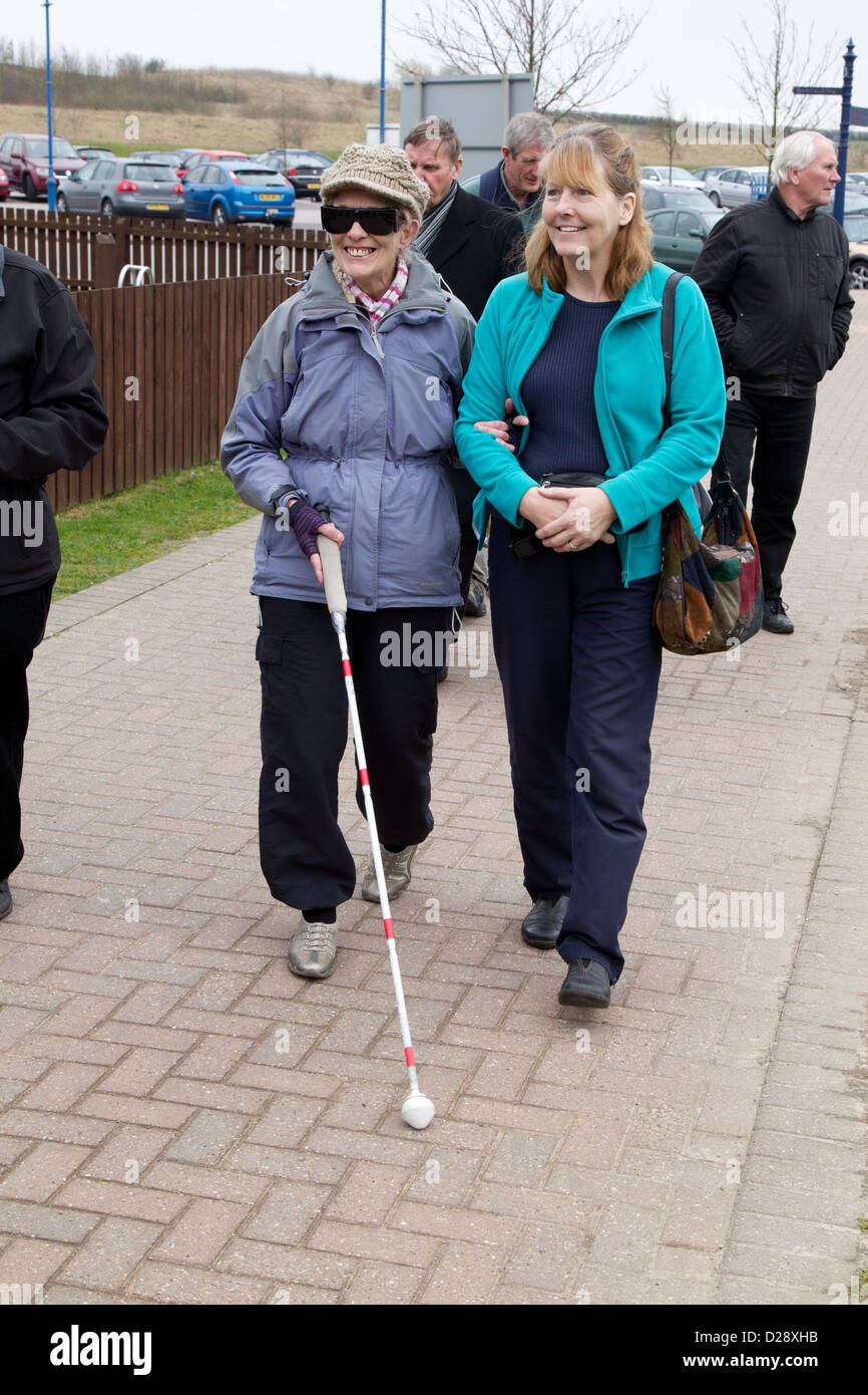 Visually impaired people with carers on outing to Denby Pottery. Woman ...