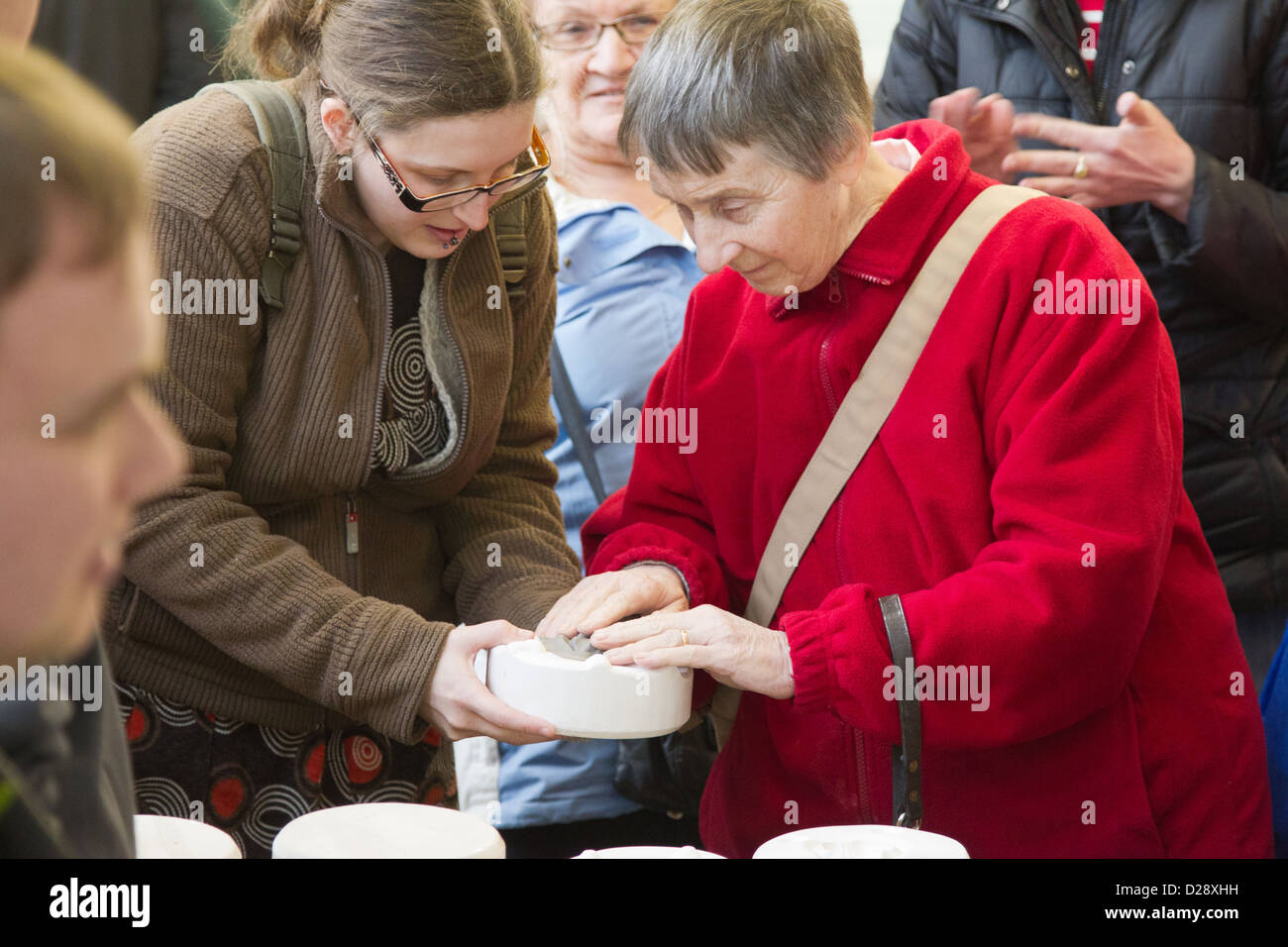 Visually impaired people with carers on outing to Denby Pottery. Woman ...