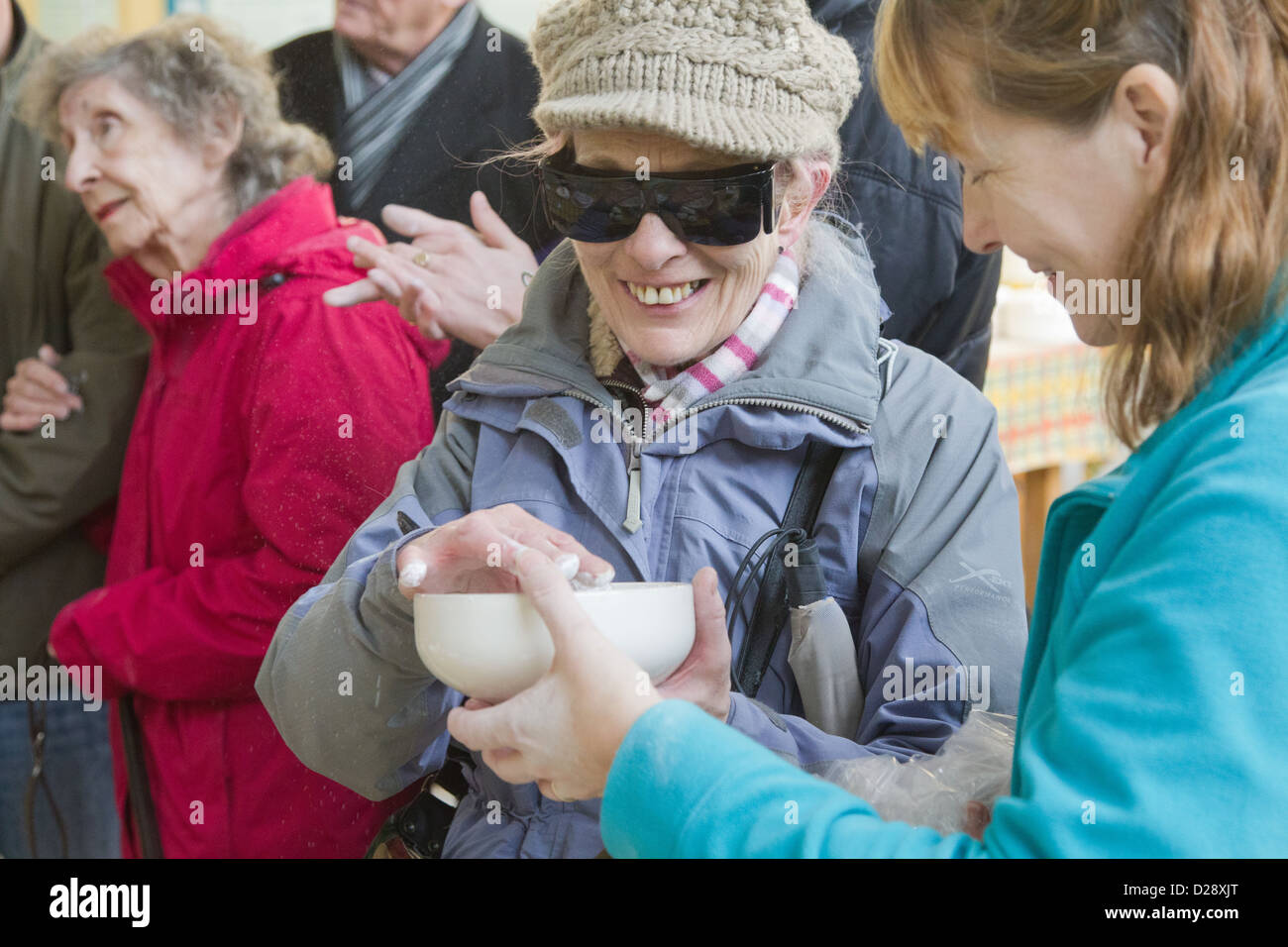 Visually impaired people with carers on outing to Denby Pottery ...