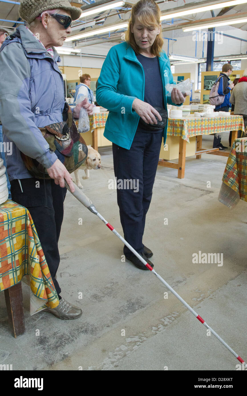 Visually impaired people with carers on outing to Denby Pottery ...