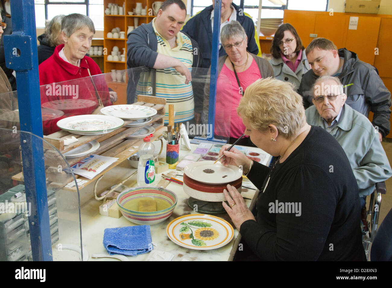 Visually impaired people with carers on outing to Denby Pottery ...