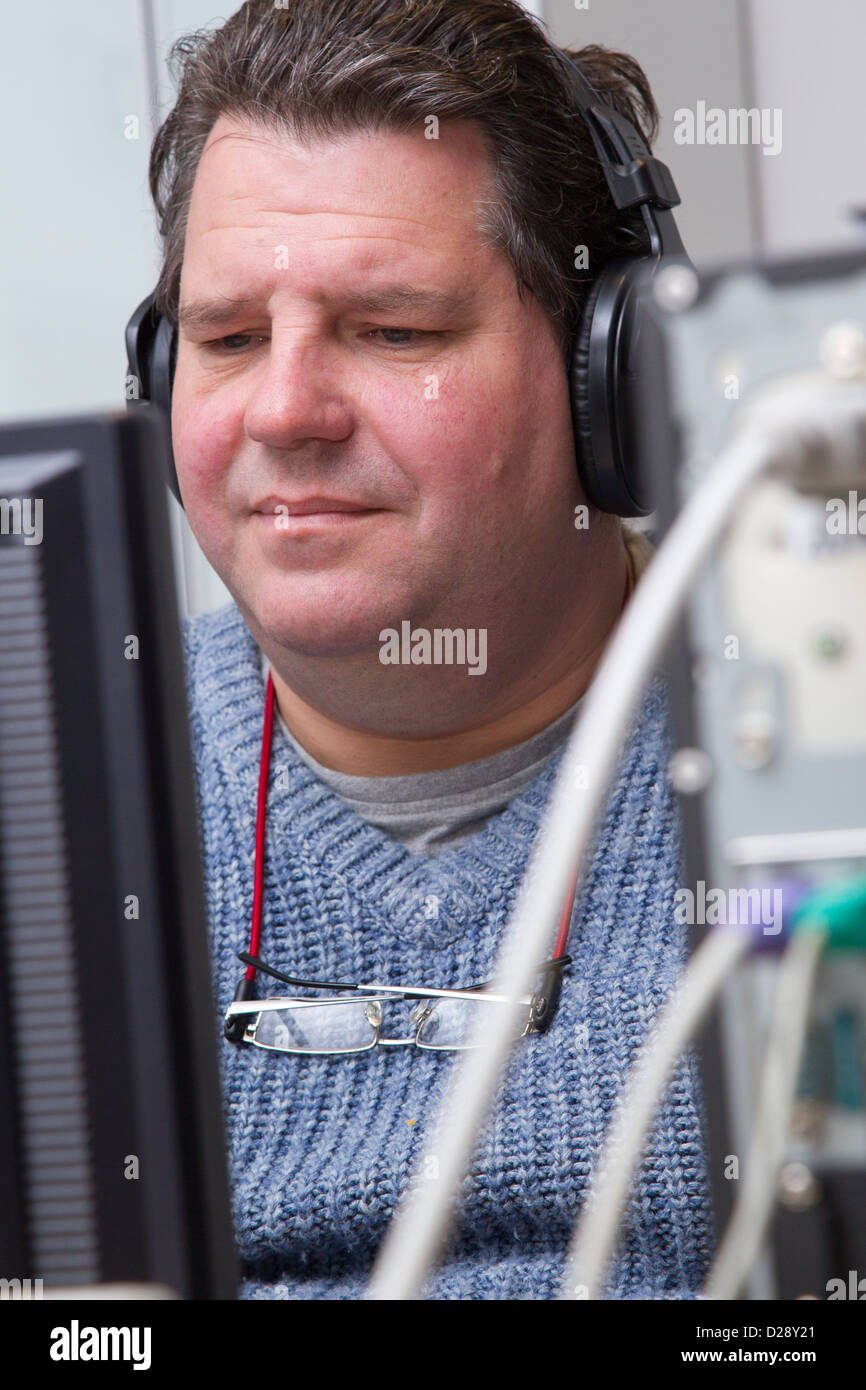 Computer class for people with visual impairments - man using ...
