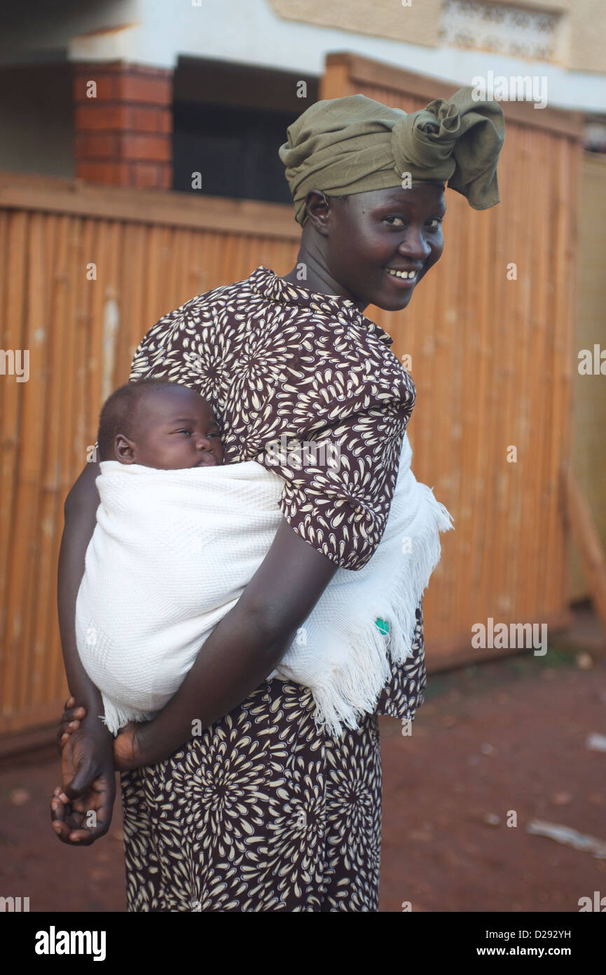 mom and a baby strapped Stock Photo - Alamy