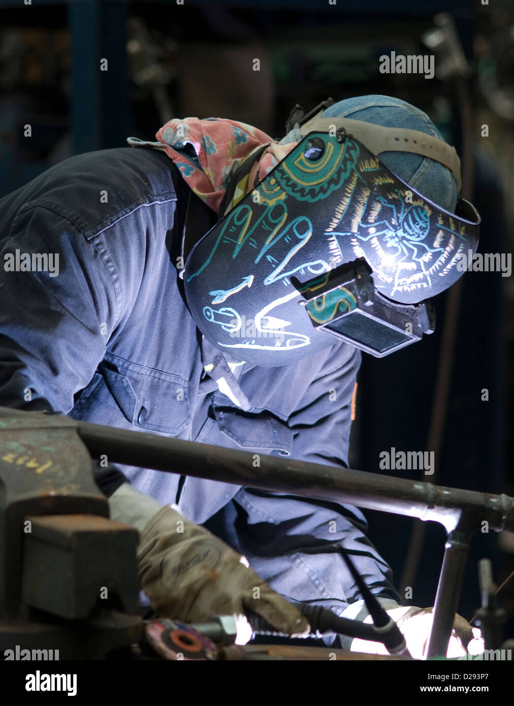 Welder with decorated mask Stock Photo - Alamy