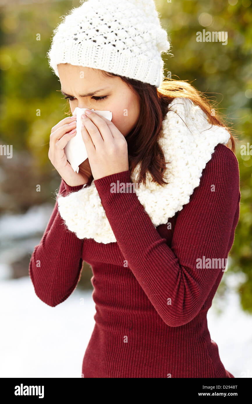 Girl with a cold sneezing Stock Photo - Alamy