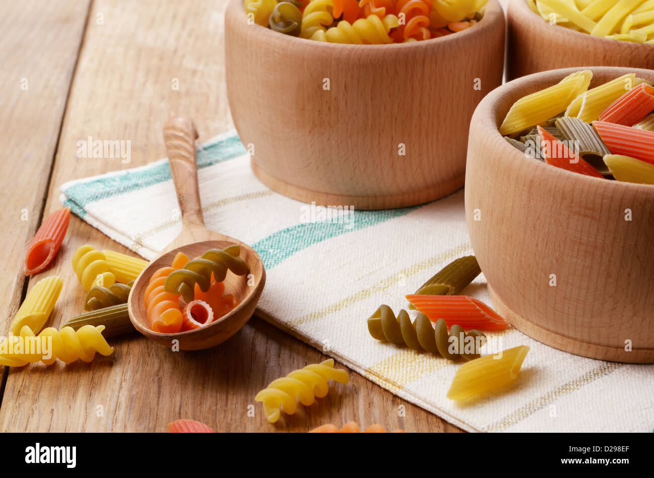 Raw tricolor pasta set on the wooden table Stock Photo - Alamy