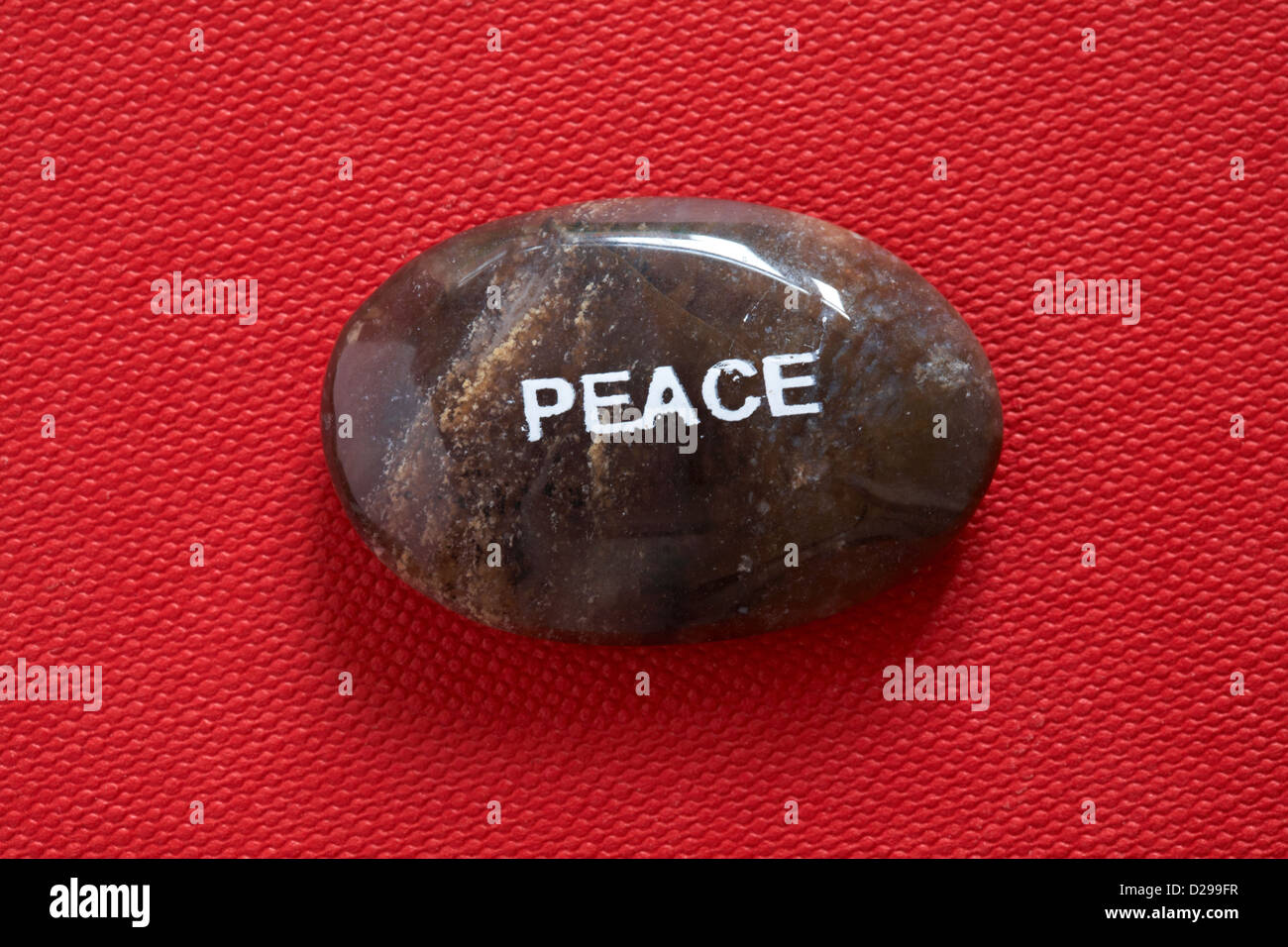 Fair Trade sentiment pebbles - Peace pebble isolated on red background ...