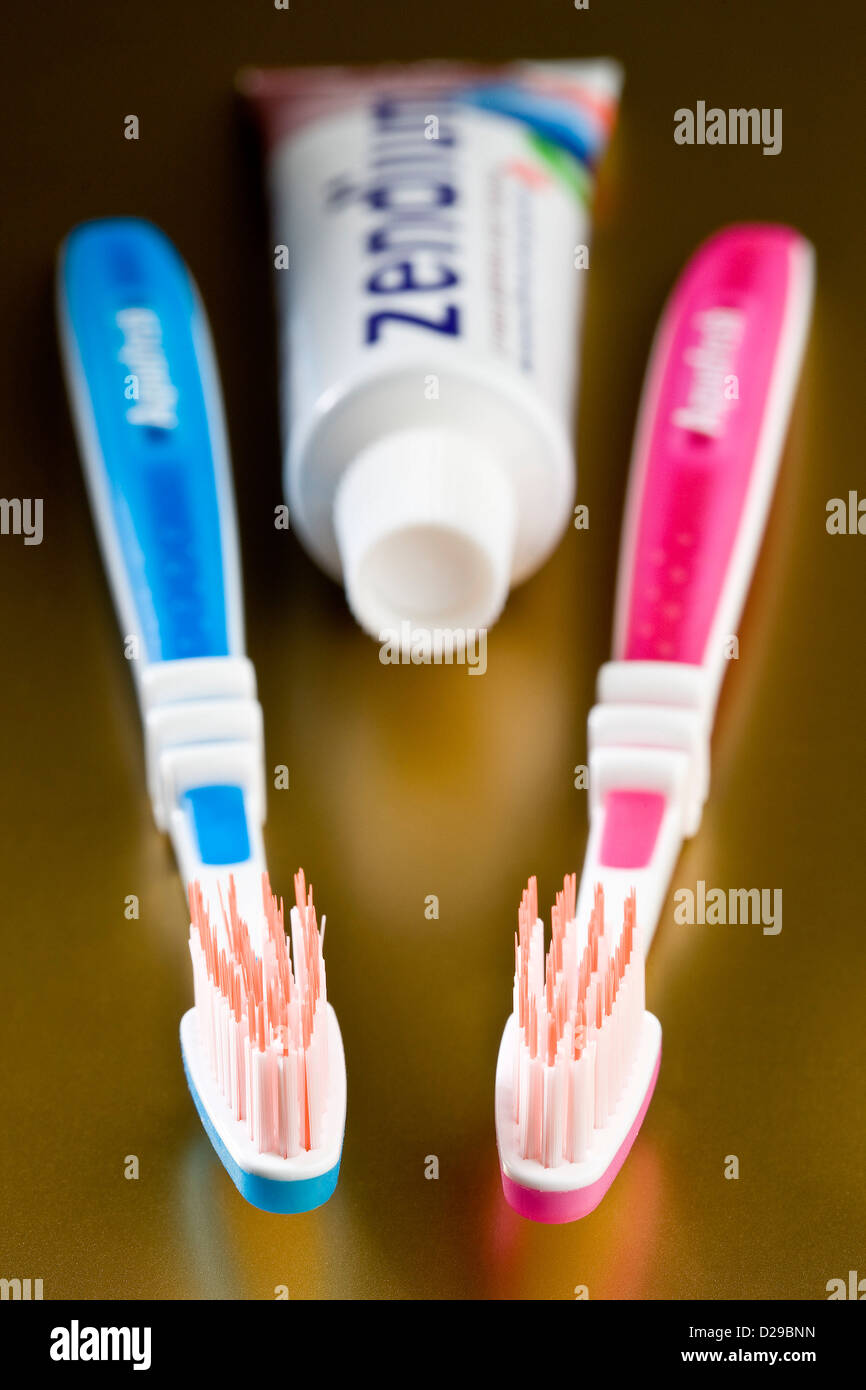 A blue and a red toothbrush and a t Stock Photo - Alamy