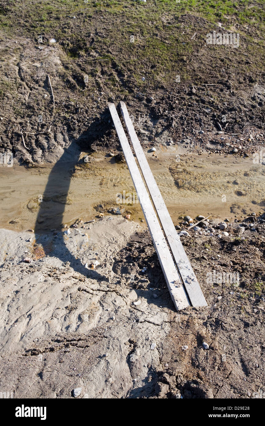 two planks crossing over ditch Stock Photo - Alamy