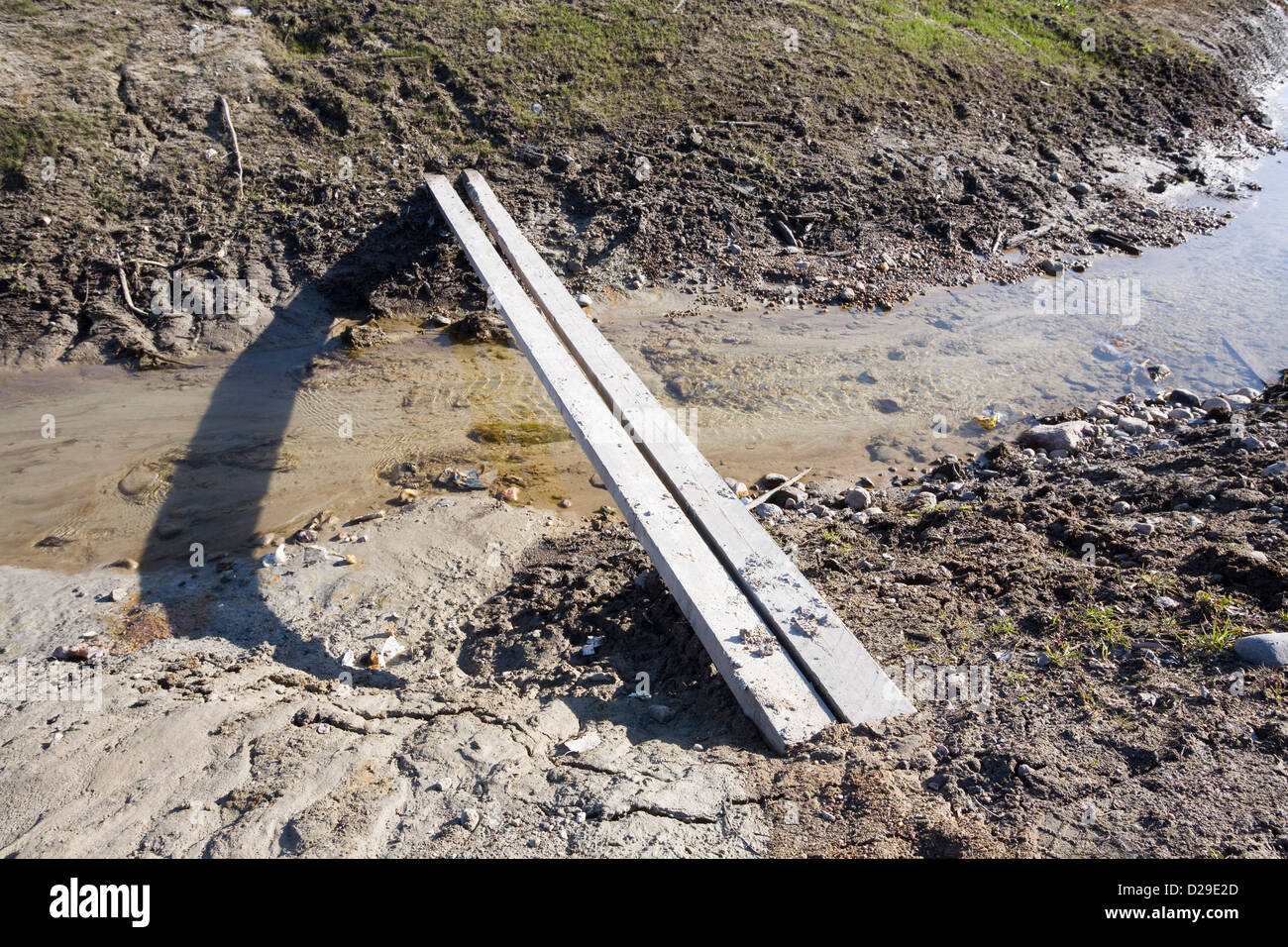 two planks crossing over ditch Stock Photo - Alamy
