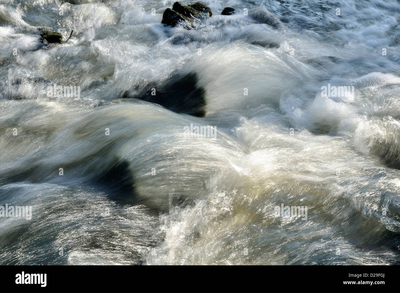 Streaming of the water of a river on stones of a dam, river : 'La ...