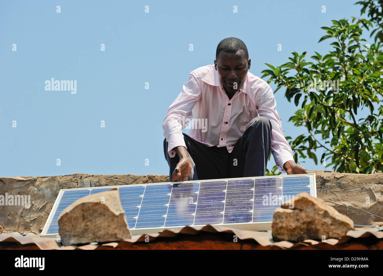 ANGOLA Kwanza Sul, village Cassombo, farmer with solar panel on the ...
