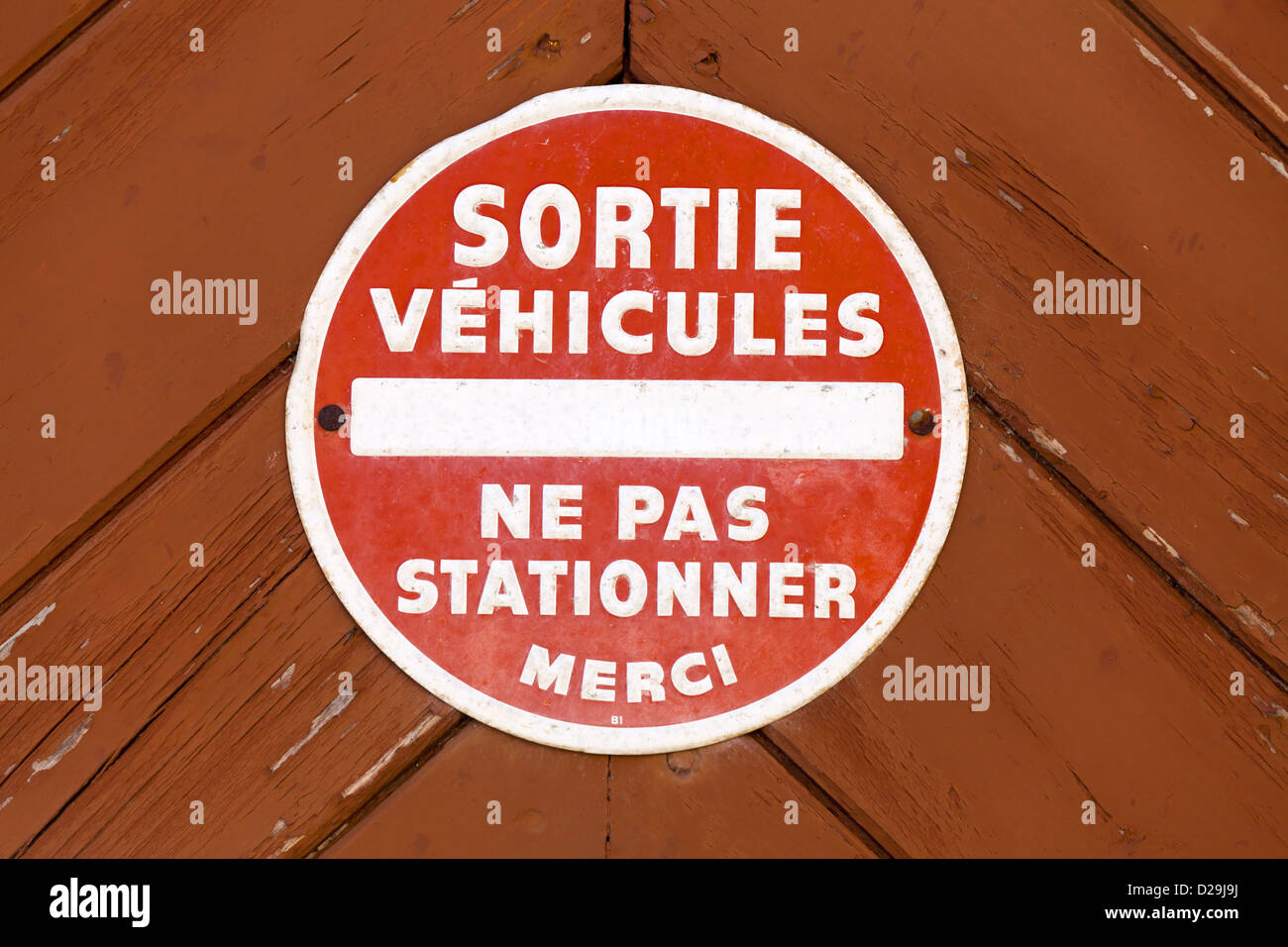 French Sign on a doorway "Sortie Véhicules - Ne pas Stationner - Merci ...