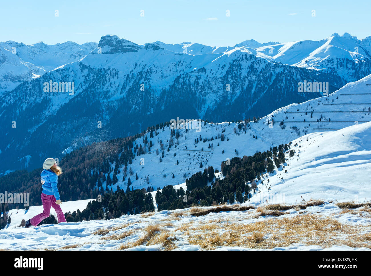 Girl playing on winter mountain slope (Sella Pass , Italy Stock Photo ...
