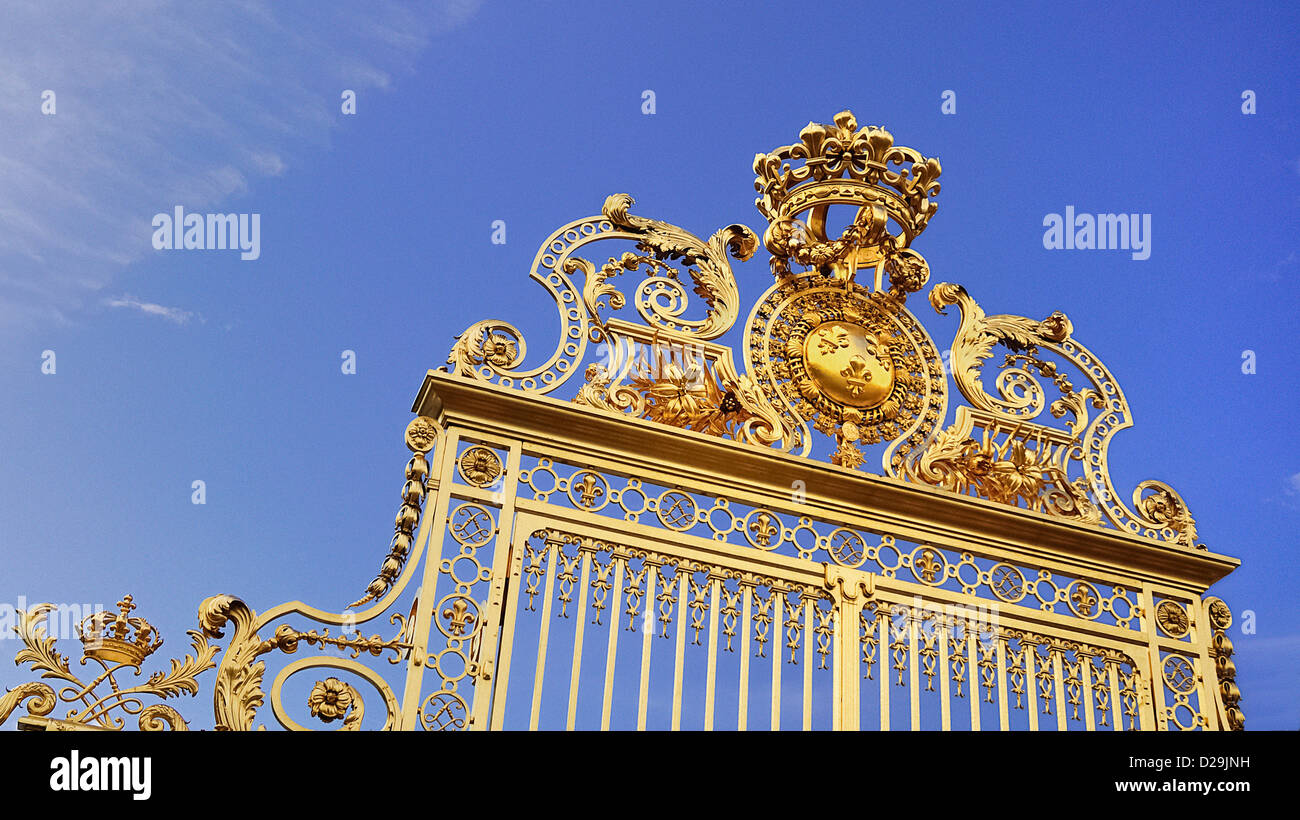 France, Ile de France, Versailles golden entrance gate against blue sky ...