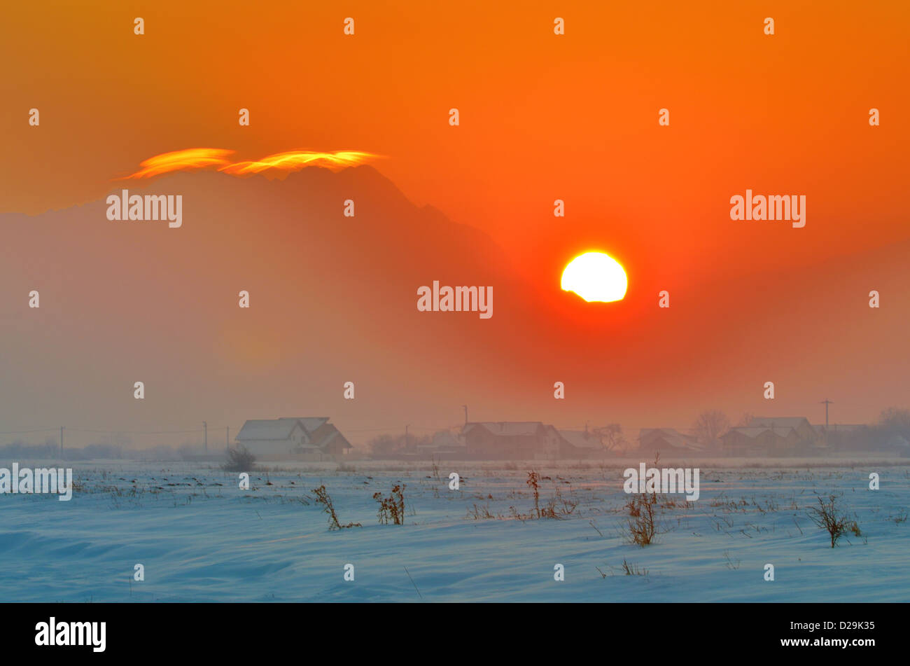 sunset over village Stock Photo - Alamy