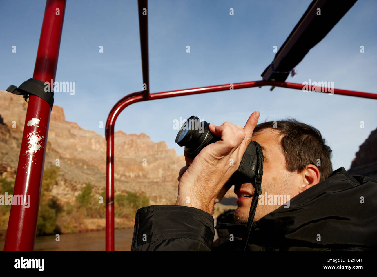 man taking photos during boat ride along the colorado river in the ...