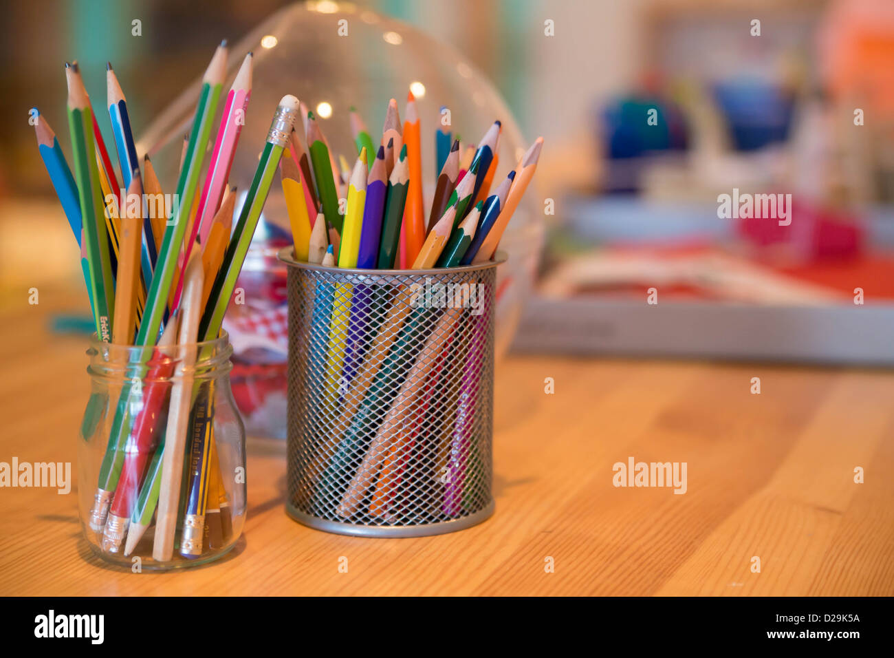 Different pencils placed at glass and plastic can Stock Photo - Alamy